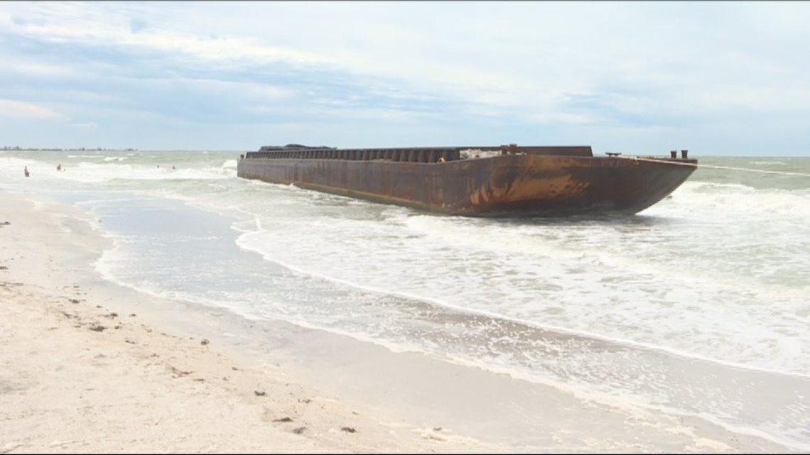 UPDATE: 40-ton barge stuck on St. Pete Beach has been towed back into ...