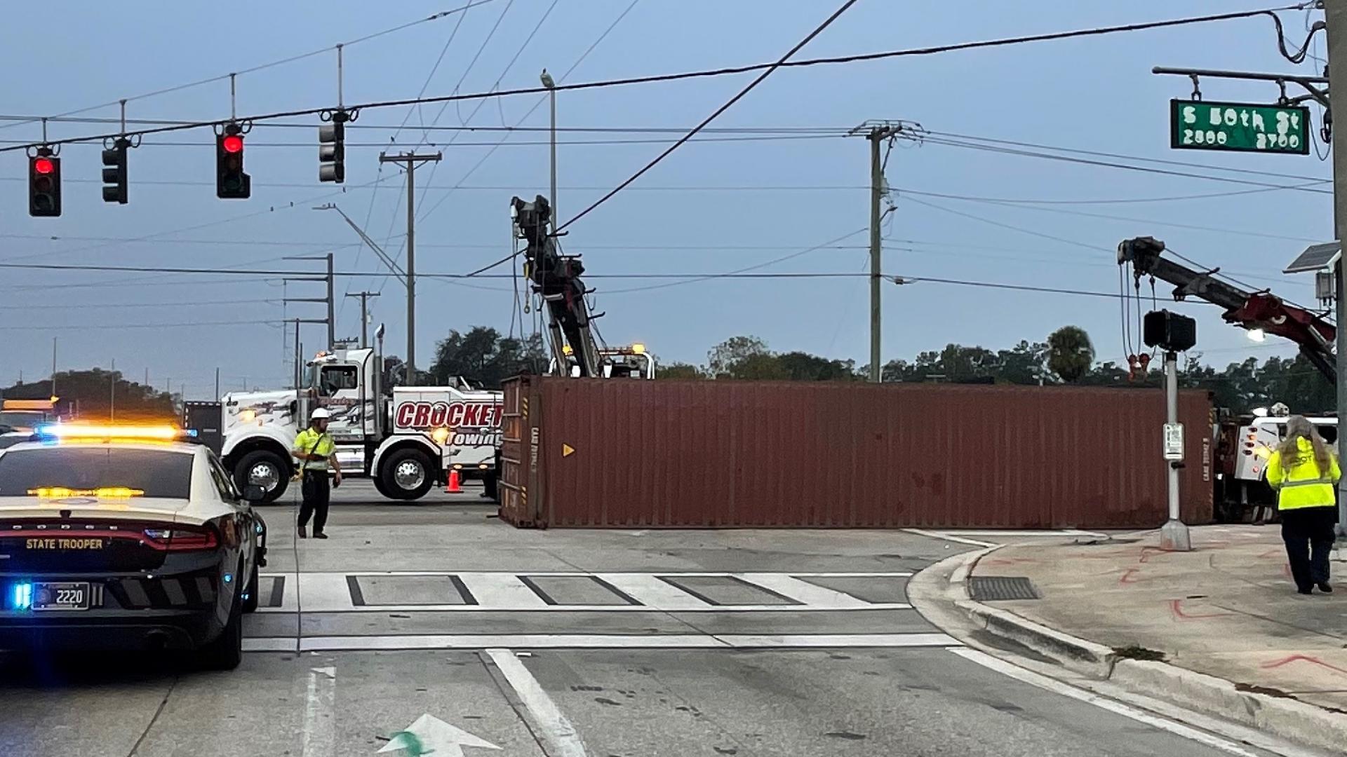 Shipping container falls off truck, takes out traffic light in ...